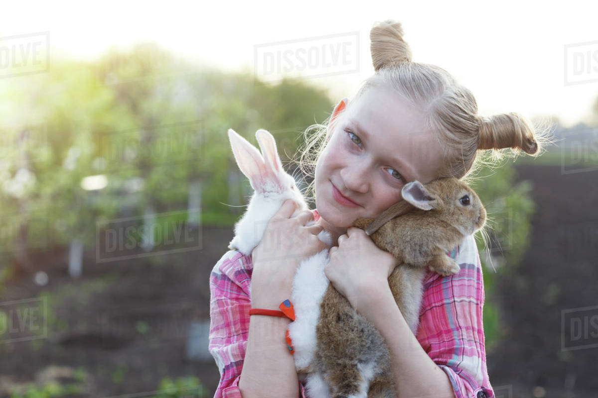 Girl and rabbit in the garden. happy childhood in the village - Stock ...