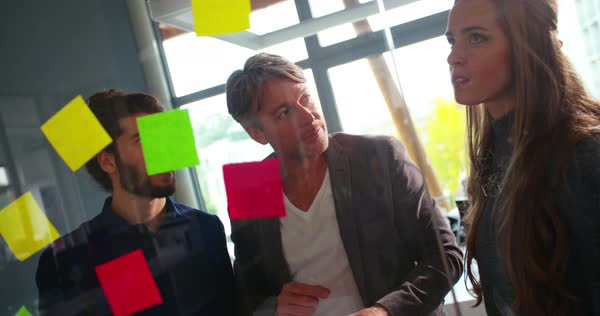 Executive team leader mind mapping business formulations with his team ...