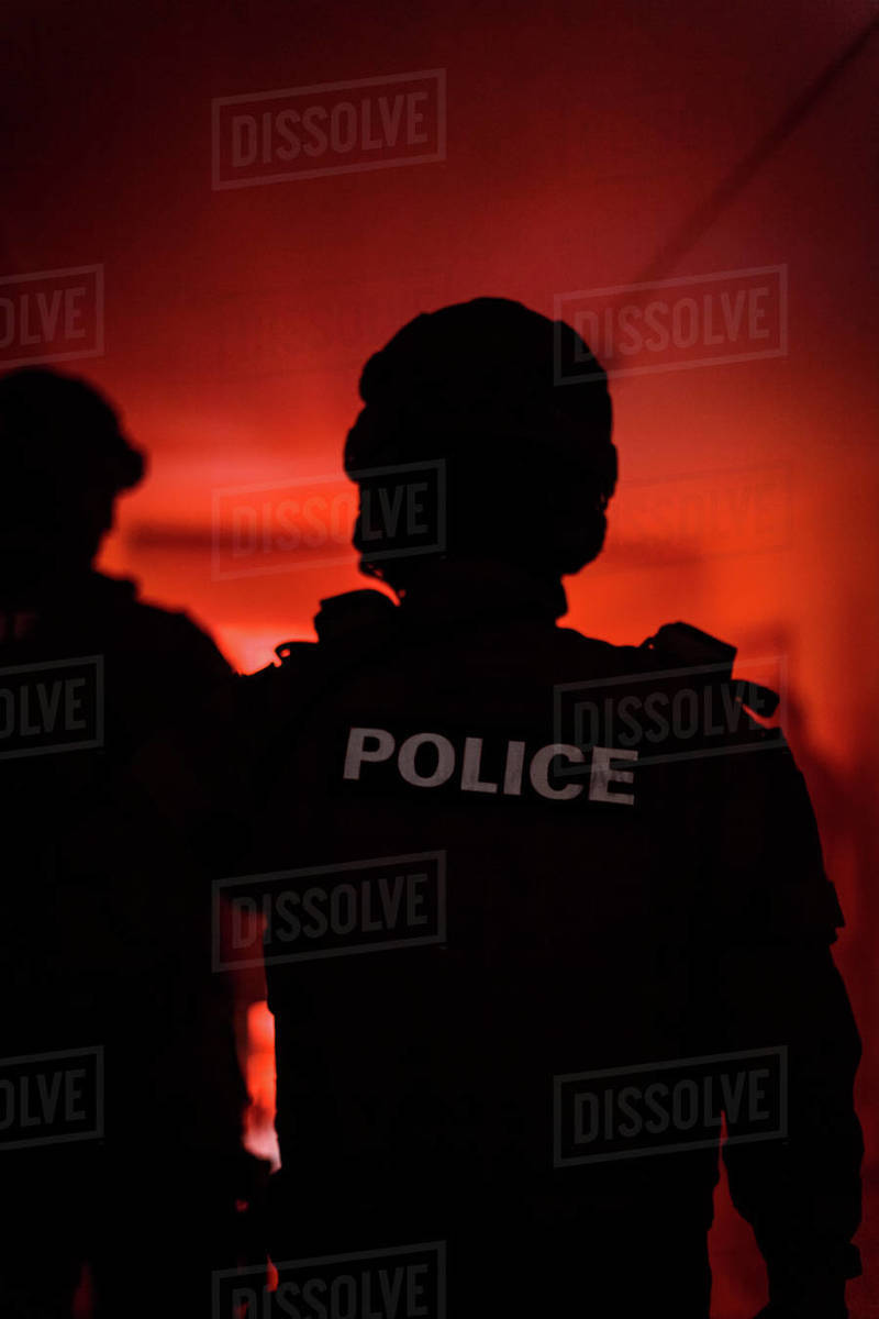 Silhouette of a police officer. Police commando in action, arresting ...