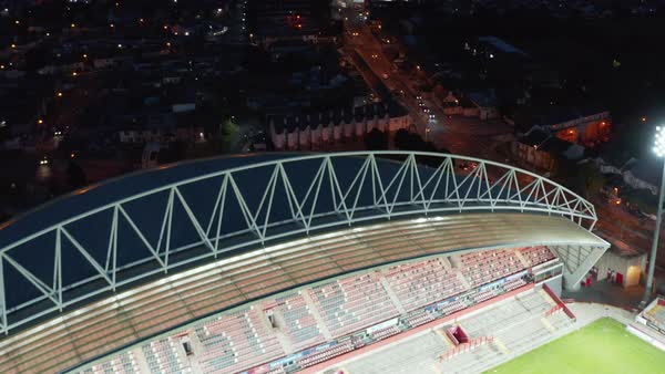 Fly over Thomond Park Stadium. Tilt up reveal night cityscape. Aerial ...