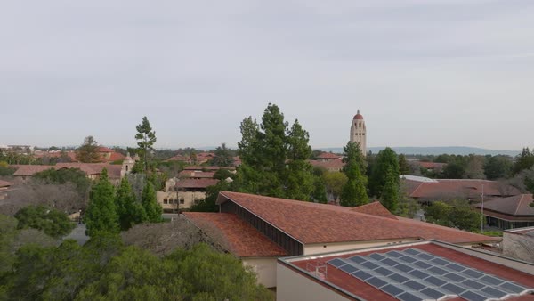 Buildings and trees in city. Rising reveal of historic Stanford ...