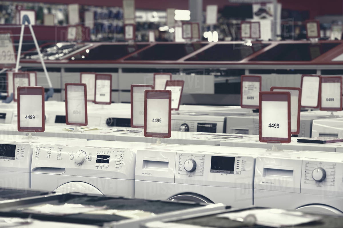 Rows of washing machines in appliance store showroom, toned version ...