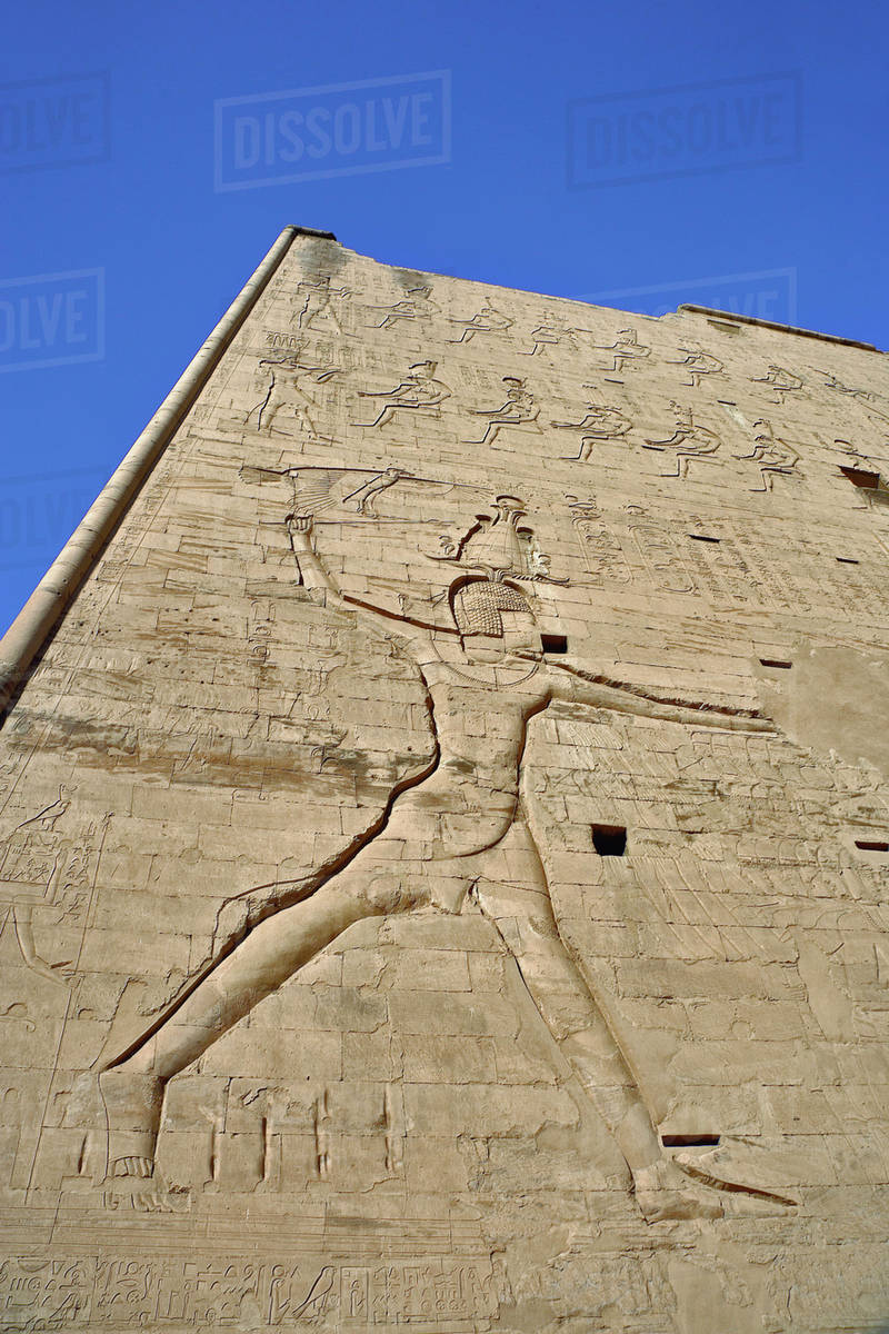 Giant figures and hieroglyphs on pylons of main entrance to Temple of ...