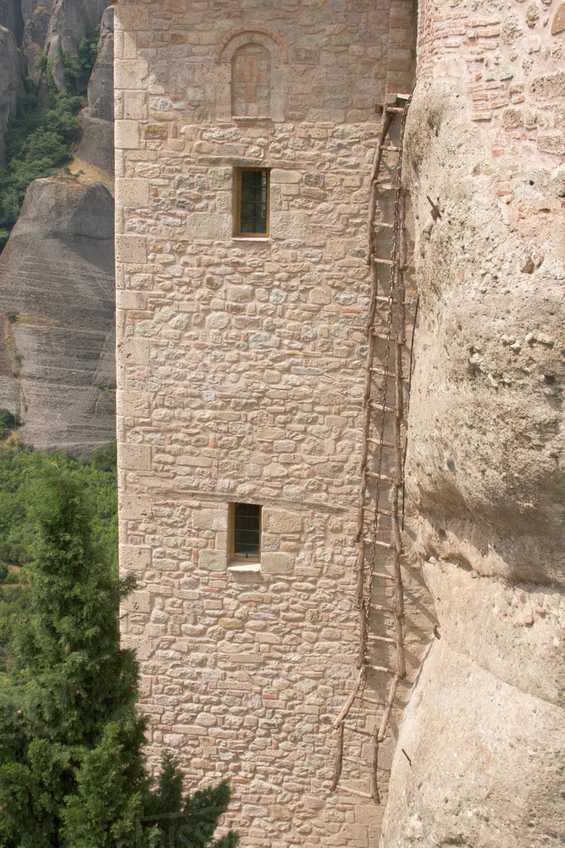 Greece, Meteora. Escape ladder and chain against stone wall at Saint ...