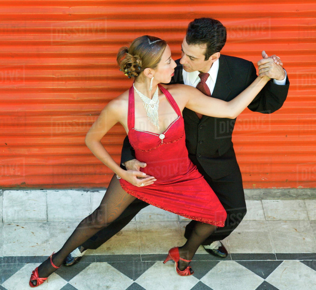 South America, Argentina, Buenos Aires, La Boca. Couple showing one of ...
