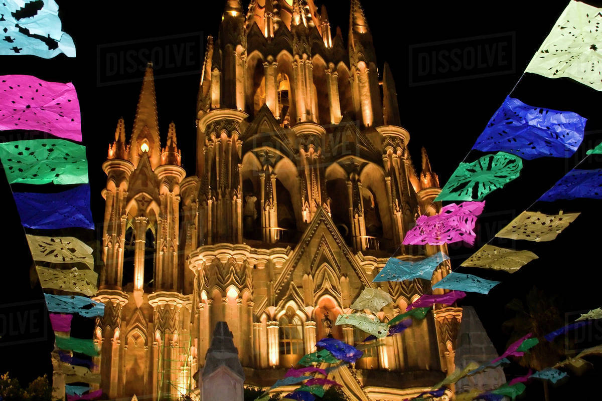 Mexico, San Miguel de Allende. Festival banners fly at night in front ...