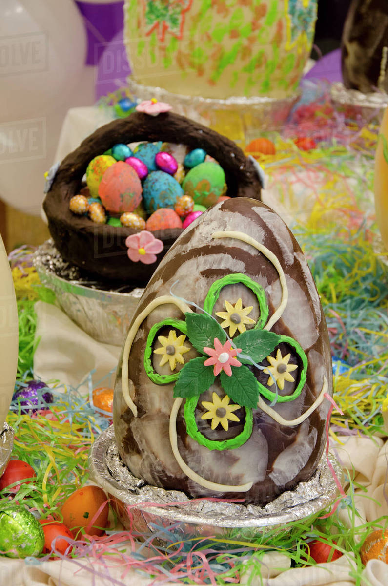 Australia. Easter display of large dark chocolate egg and basket of ...