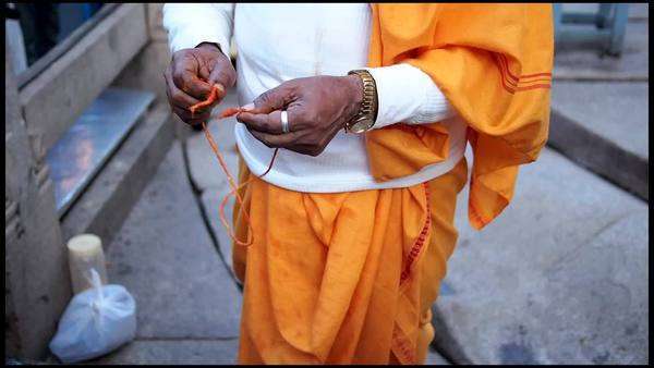 Jain priest at work at the Jain temple in Shravanabelagola, Karnataka ...