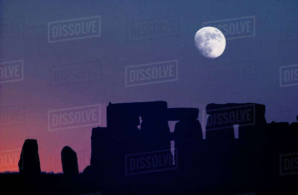 Europe, Stonehenge. The moon sets over prehistoric Stonehenge, a World ...