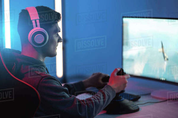 The young gamer playing online video game on his personal computer ...