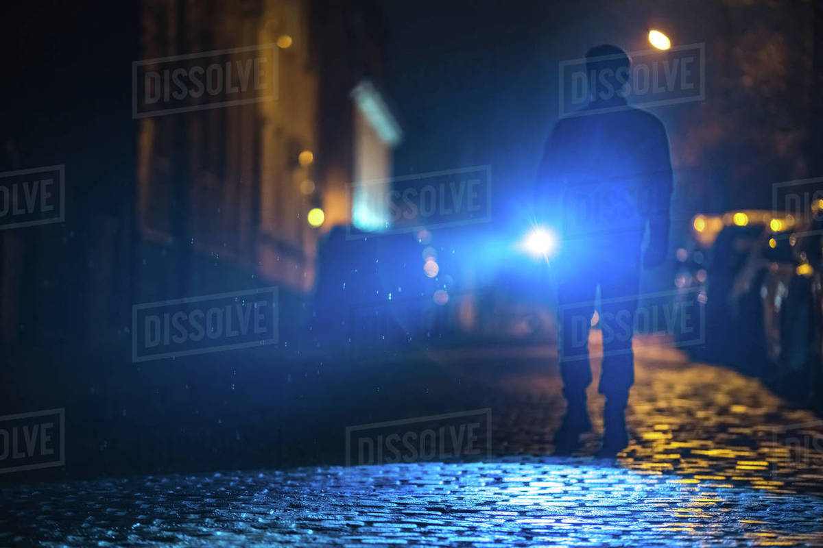 The man with a flashlight inspect the road. Evening night time - Stock ...