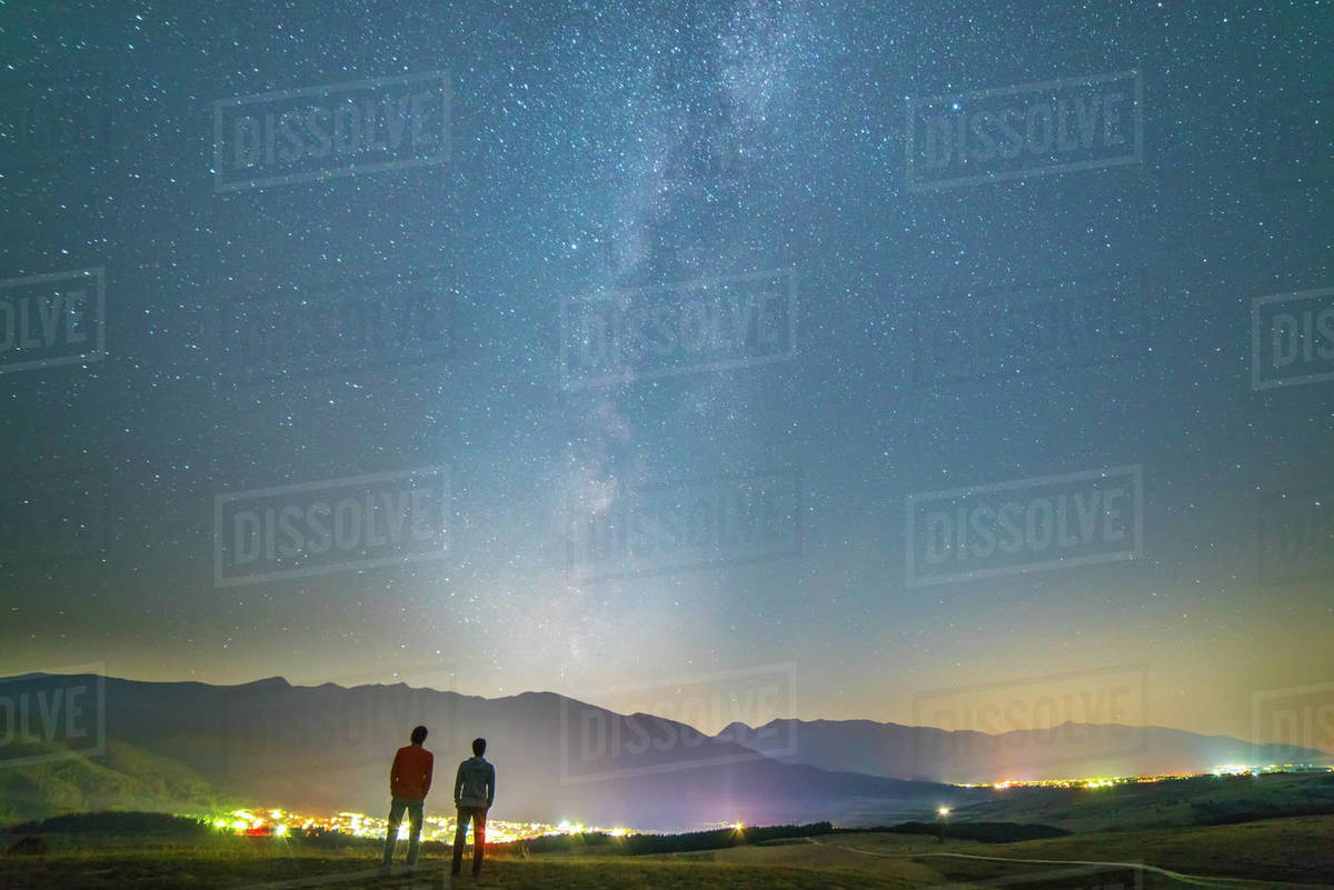 The two friends stand on the background of the stars. night time ...