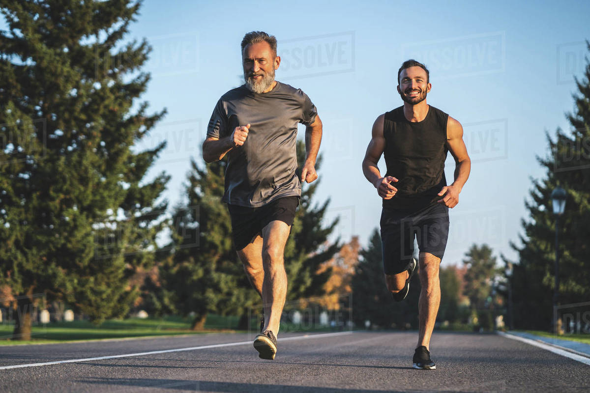 The father and a son running on the park road - Royalty-free Stock ...