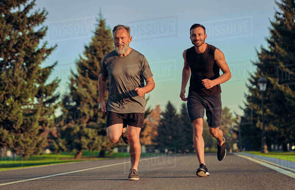 The old and young sportsmen running on the road - Royalty-free Stock ...