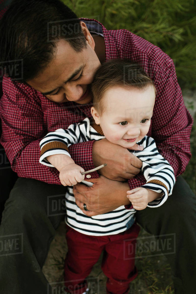 Father hugging smiling baby boy - Royalty-free Stock Photo | Dissolve
