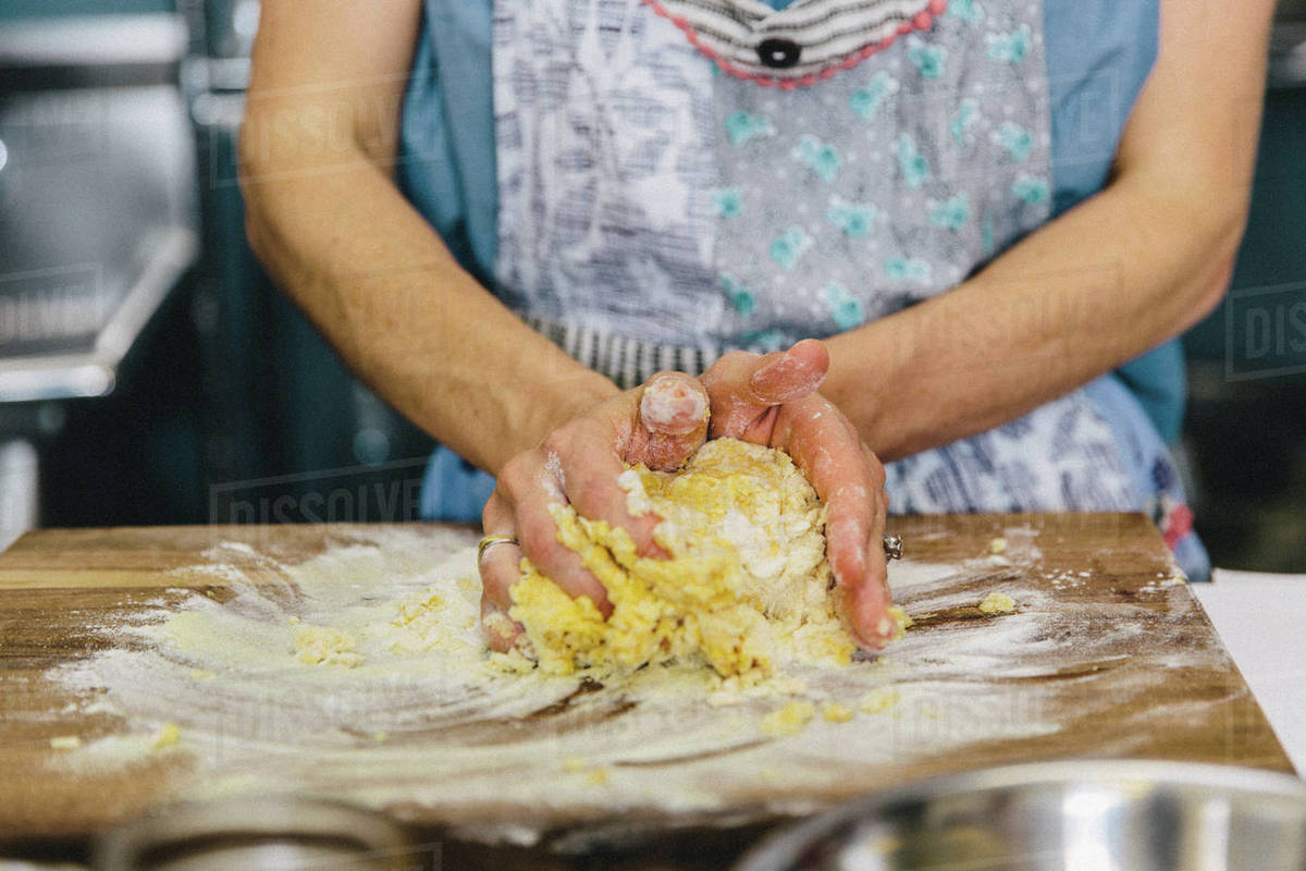 Woman kneading pasta dough - Royalty-free Stock Photo | Dissolve