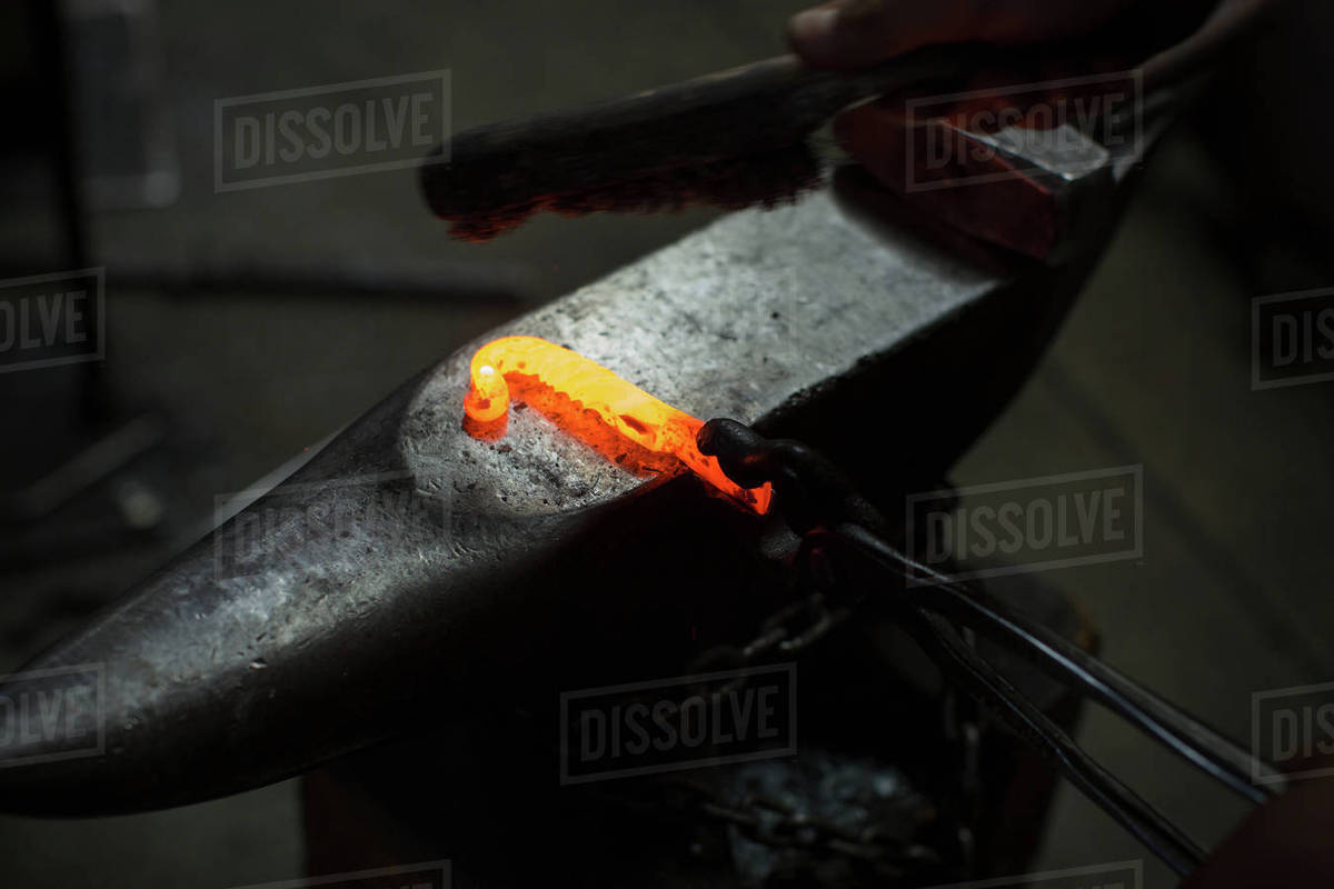 Red hot metal rod on metal workshop anvil - Royalty-free Stock Photo ...