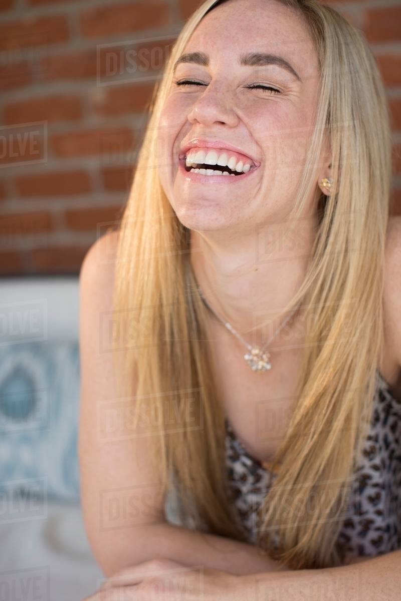 Portrait of young woman with long blonde hair laughing - Royalty-free ...