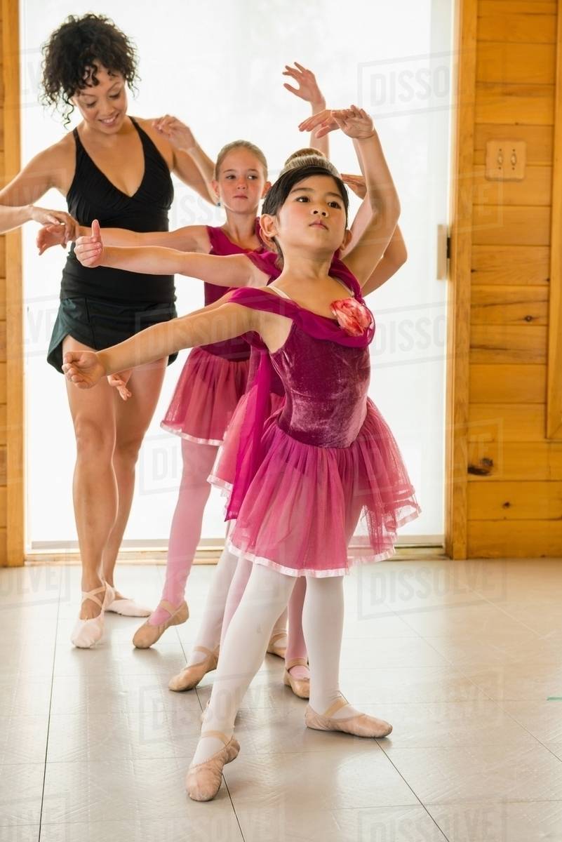 Ballerinas practising with ballet teacher - Stock Photo - Dissolve