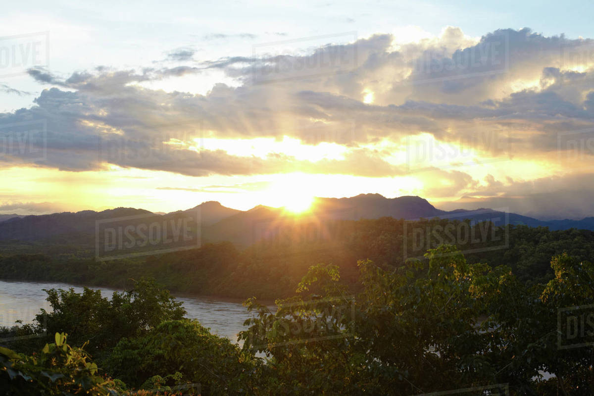 Sun rising over mountain range - Royalty-free Stock Photo | Dissolve