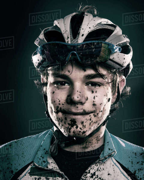 Mud splattered cyclist smiling - Royalty-free Stock Photo | Dissolve