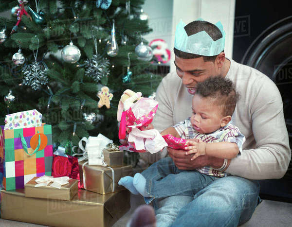 Father and baby boy opening christmas presents - Royalty-free Stock ...