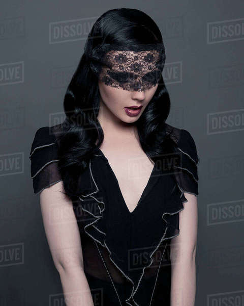 Portrait of young woman with black lace covering eyes - Royalty-free ...