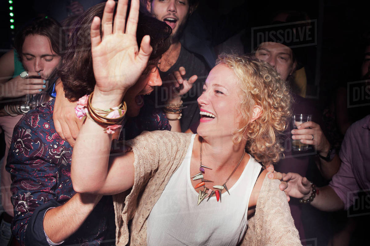 Group of friends celebrating in club - Royalty-free Stock Photo | Dissolve