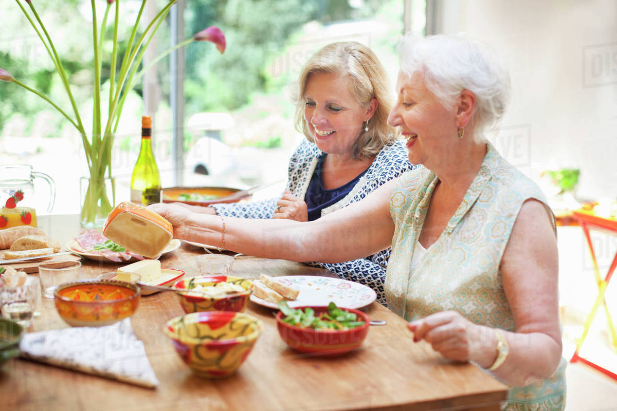 Two women having lunch together at home - Royalty-free Stock Photo ...