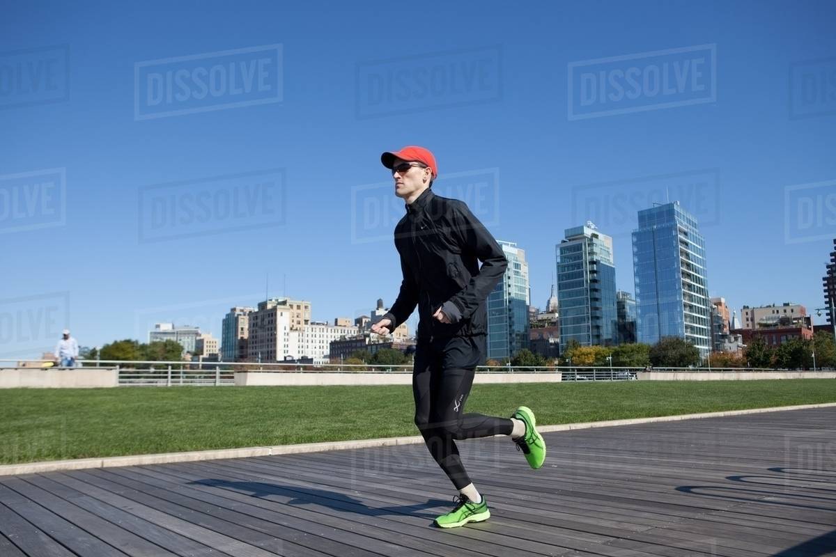 Man jogging on timber walkway - Stock Photo - Dissolve