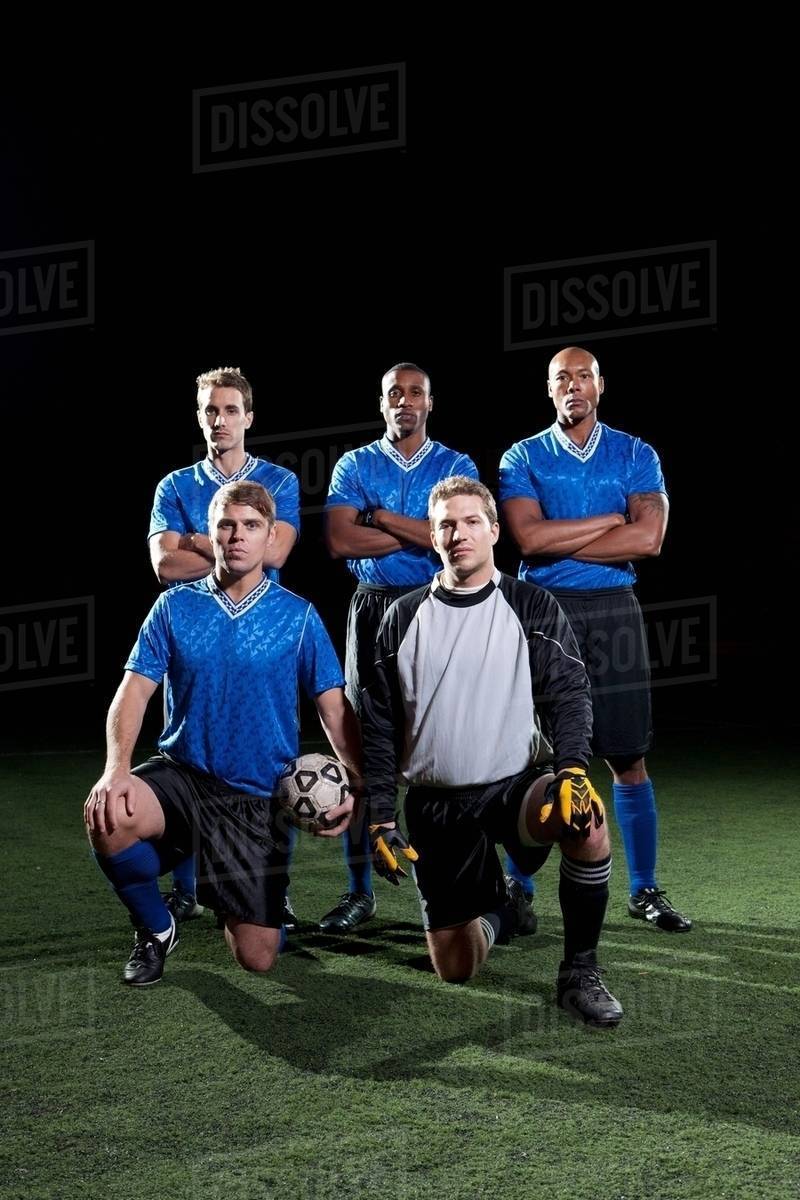 Soccer team on pitch at night - Royalty-free Stock Photo | Dissolve