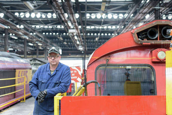 Portrait of locomotive engineer working in train works - Stock Photo ...