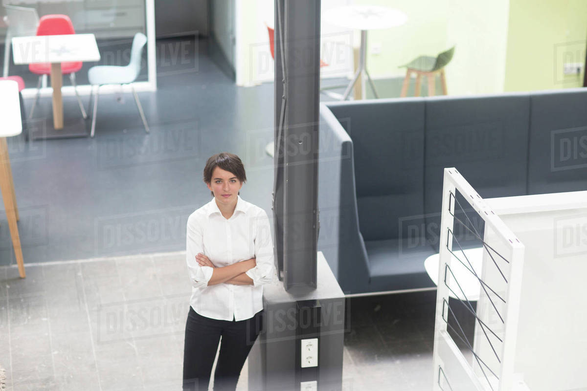 Portrait of young female sales manager in office furniture store, high ...
