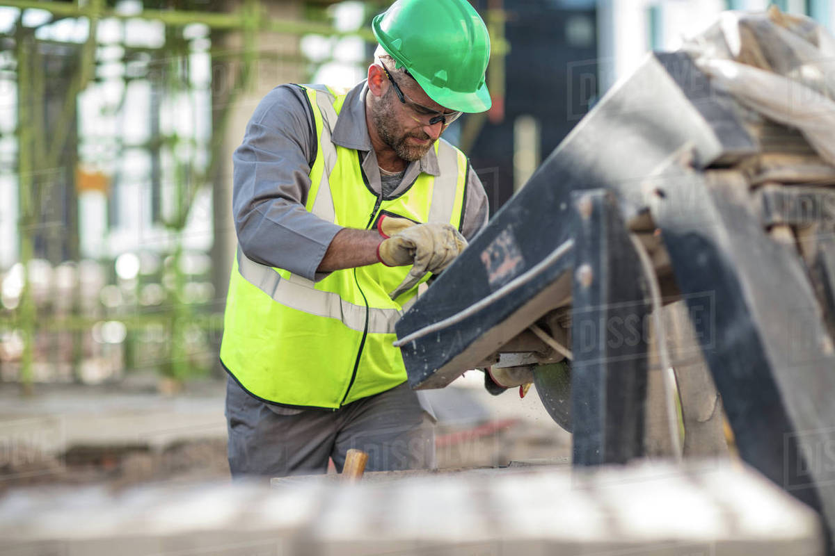 Construction worker using heavy machinery - Royalty-free Stock Photo ...
