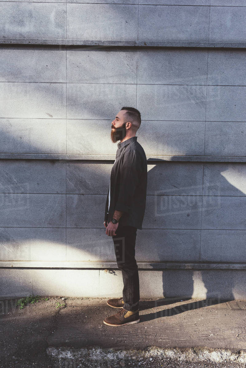 Full length side view portrait of bearded man - Stock Photo - Dissolve