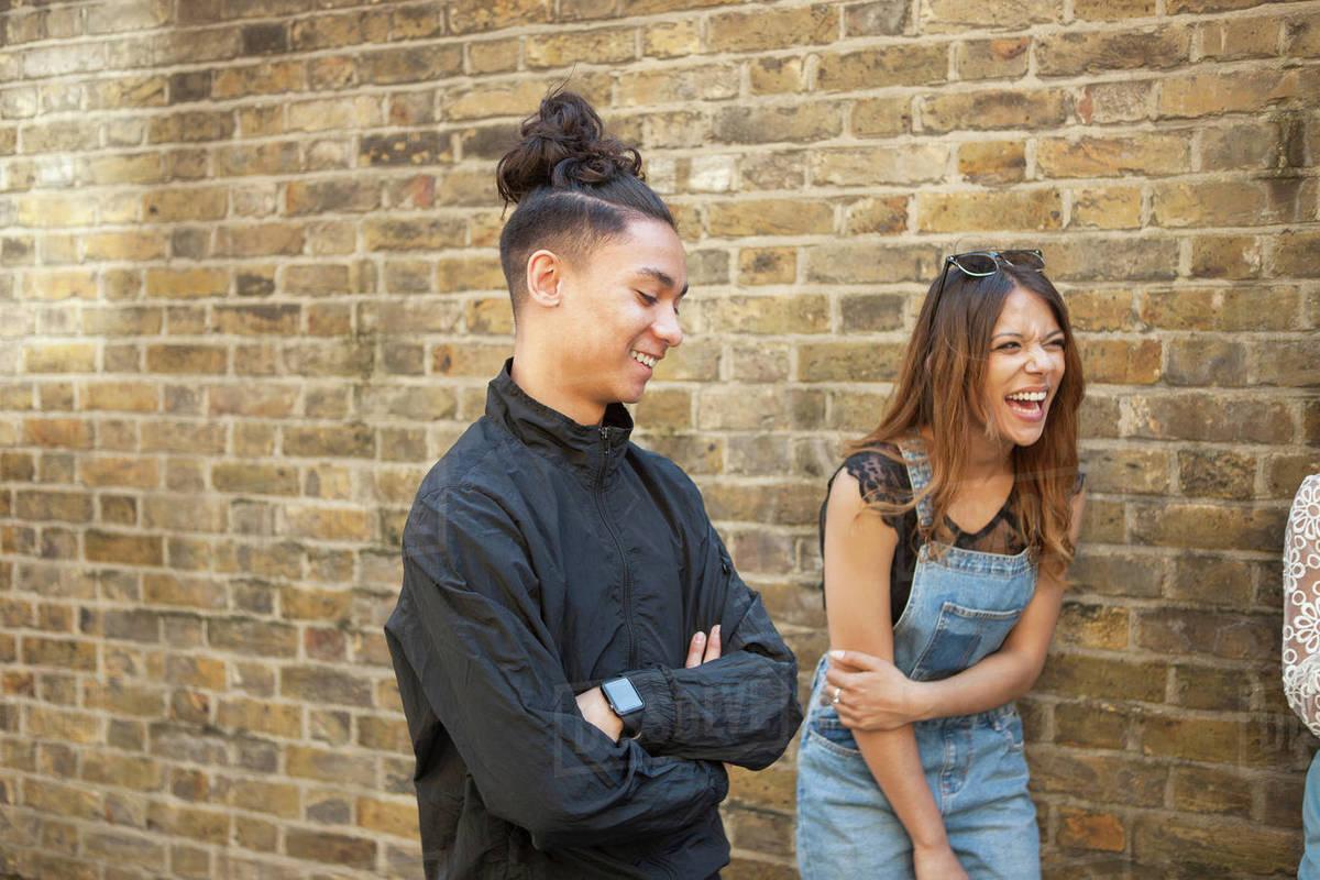 Young couple fooling around in street - Stock Photo - Dissolve