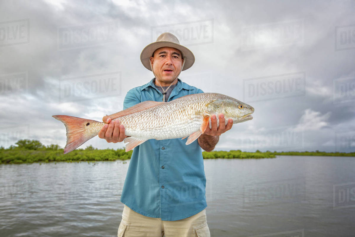 Man holding huge redfish - Royalty-free Stock Photo | Dissolve