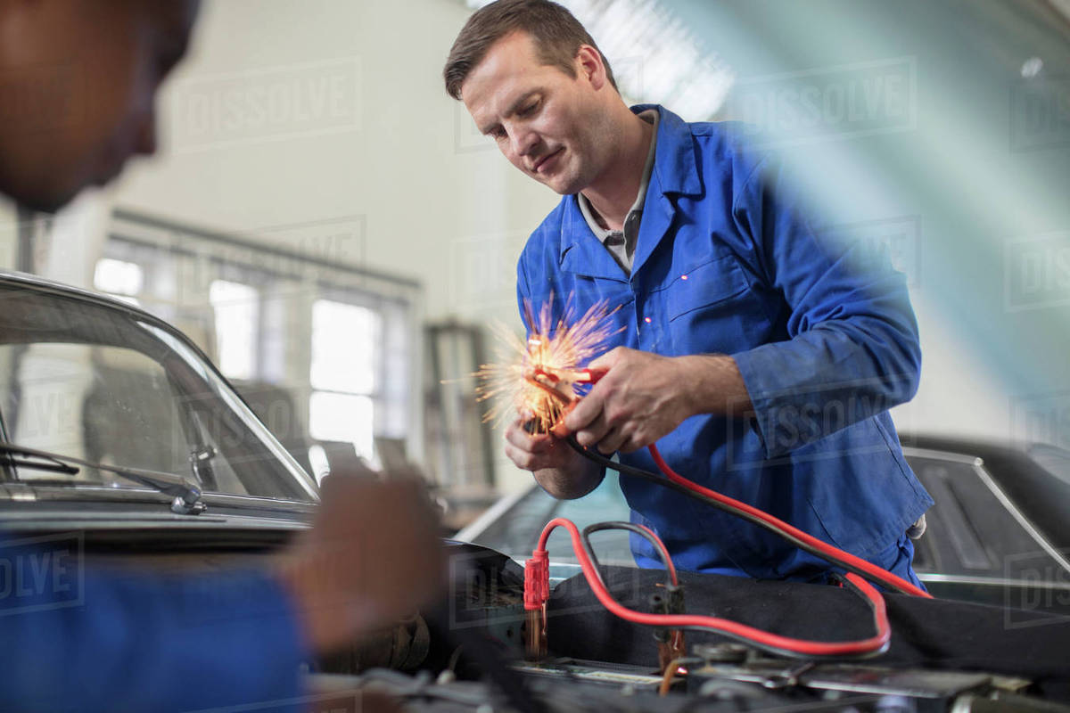 Car mechanics testing car engine in repair garage - Royalty-free Stock ...