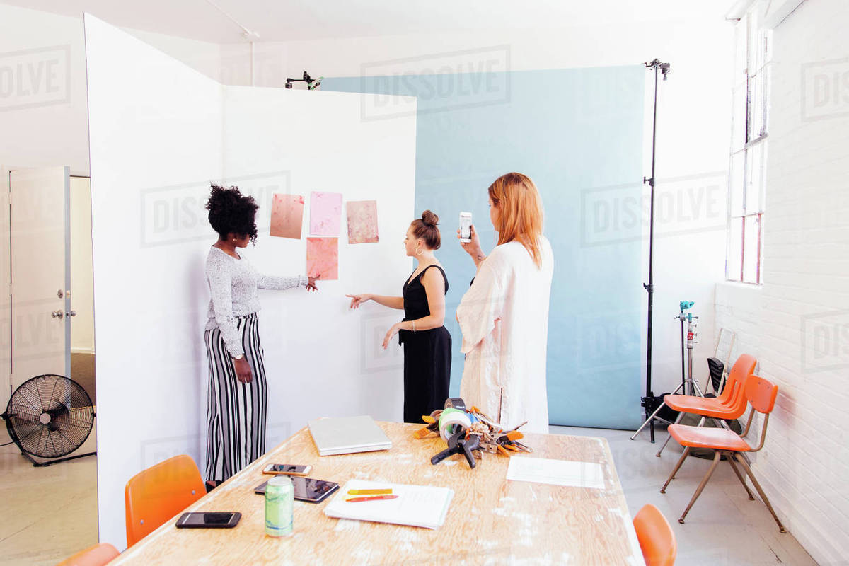 Colleagues in creative studio discussing swatches - Stock Photo - Dissolve