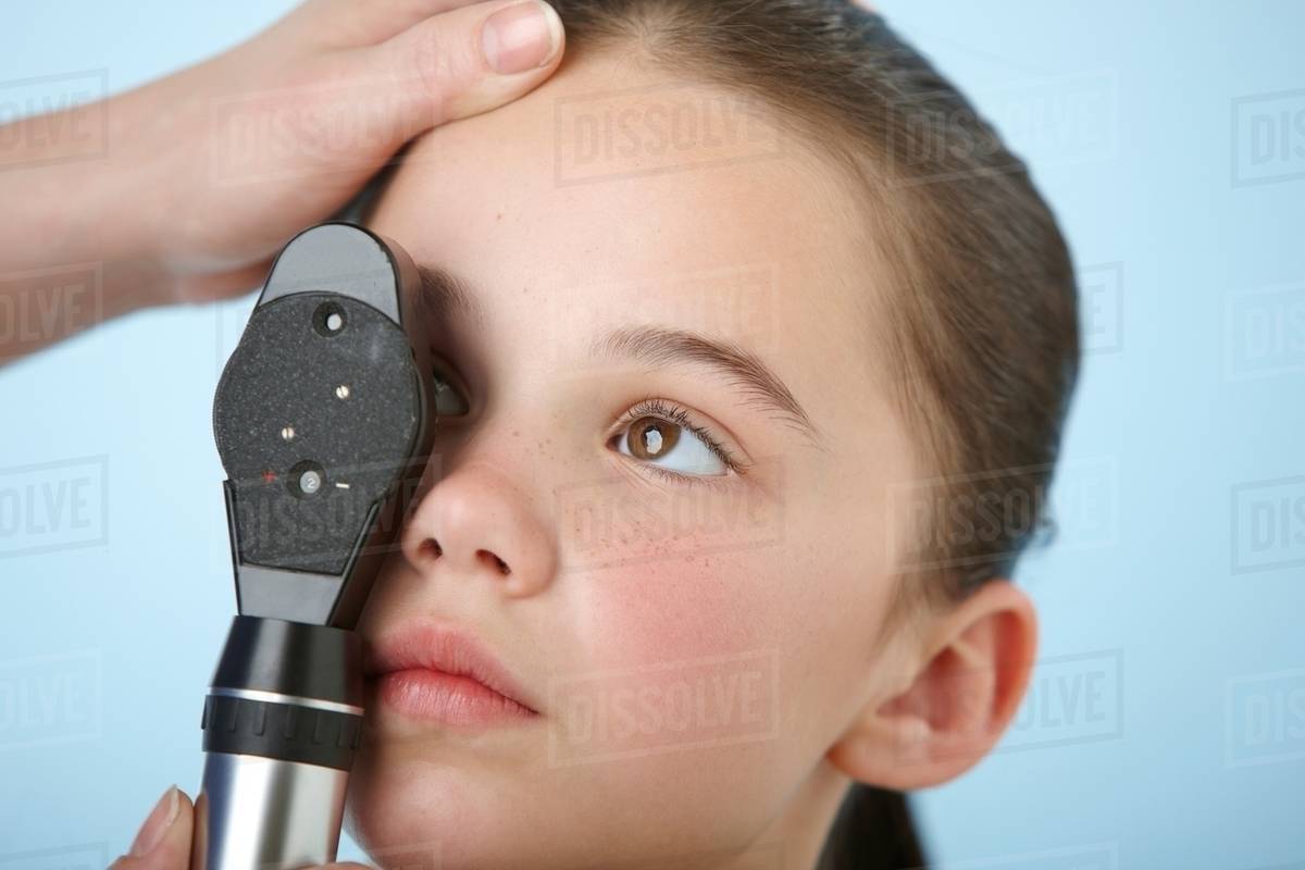 Girl having eye test - Stock Photo - Dissolve