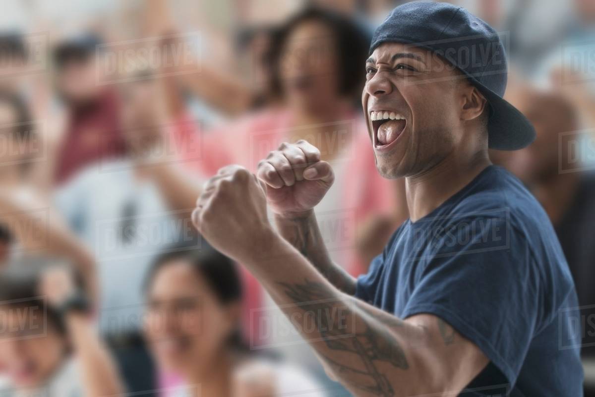 Man cheering at sports game - Royalty-free Stock Photo | Dissolve