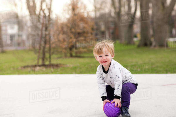 Boy playing ball in park - Royalty-free Stock Photo | Dissolve