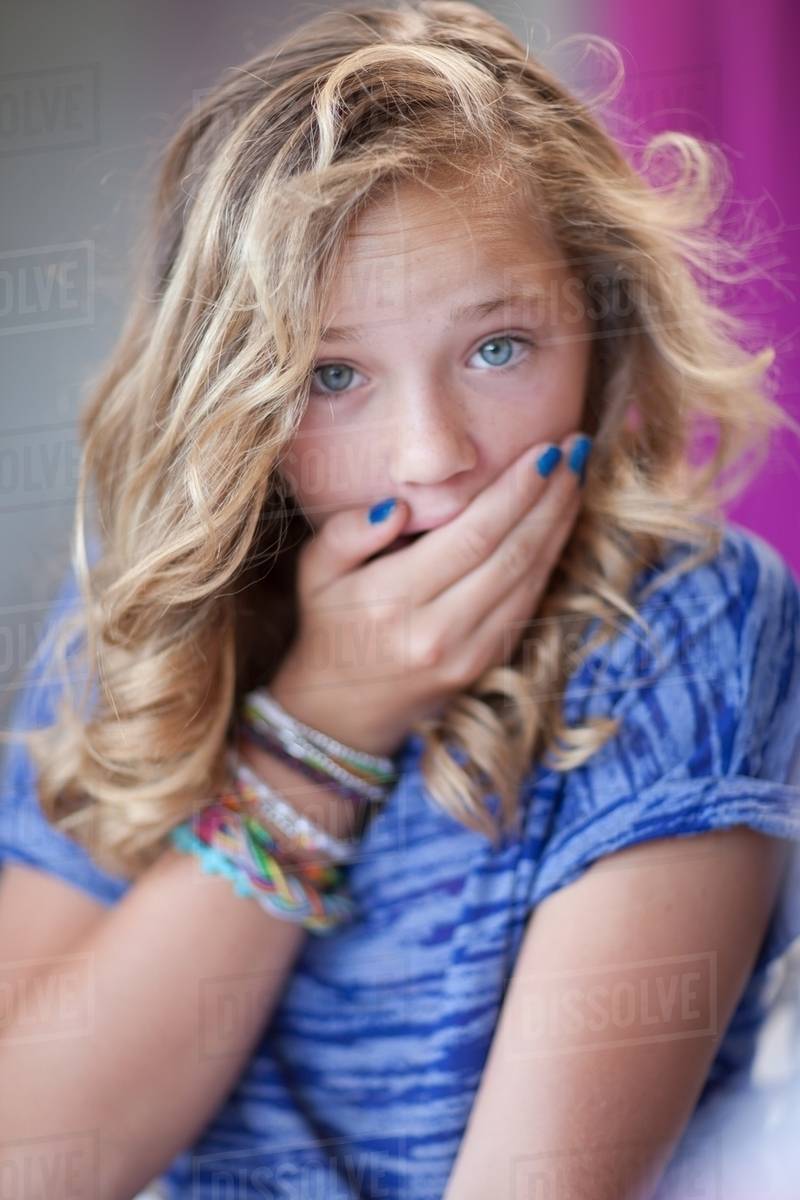 Girl gasping with hand over mouth - Royalty-free Stock Photo | Dissolve