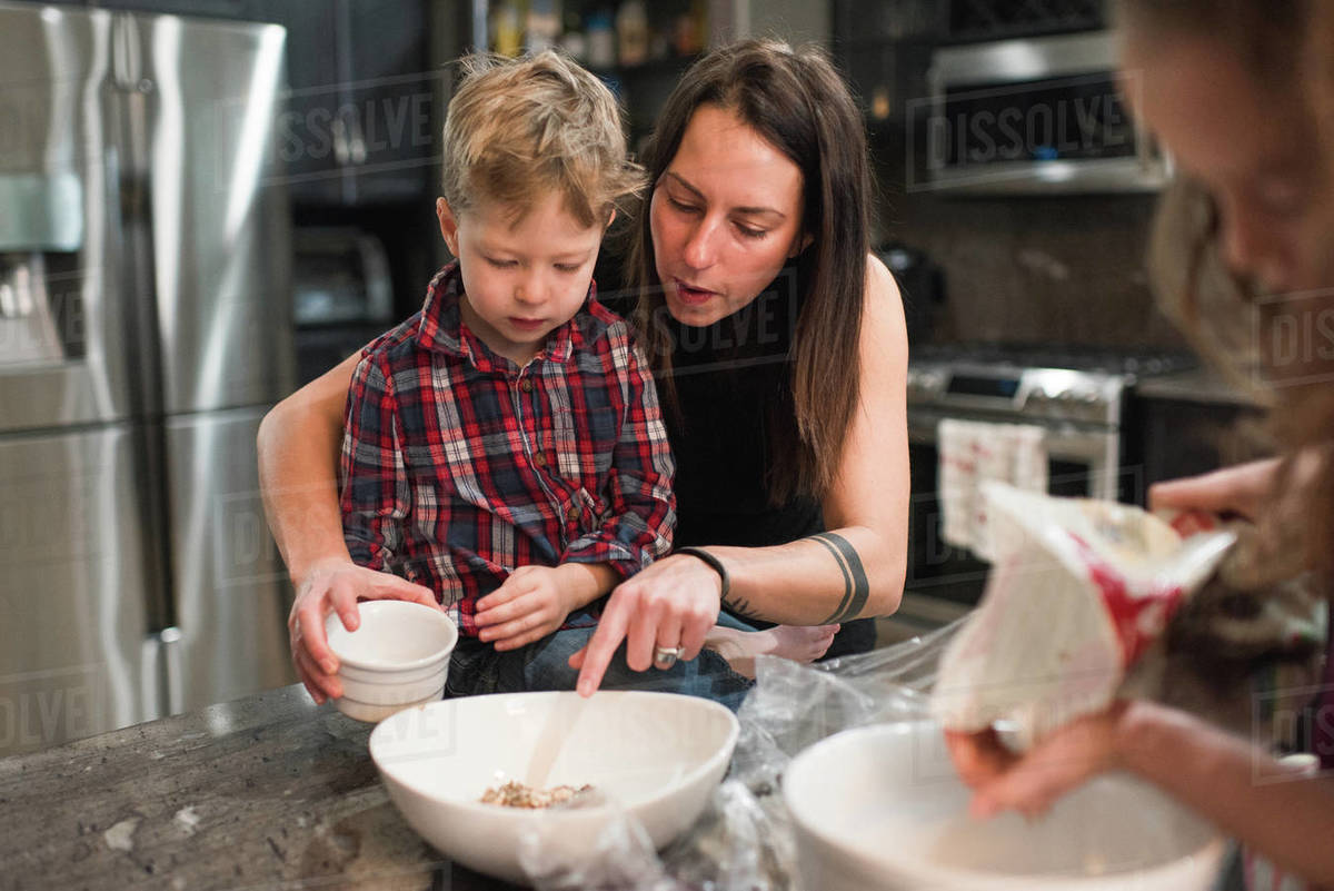 Children helping mother in kitchen - Royalty-free Stock Photo | Dissolve