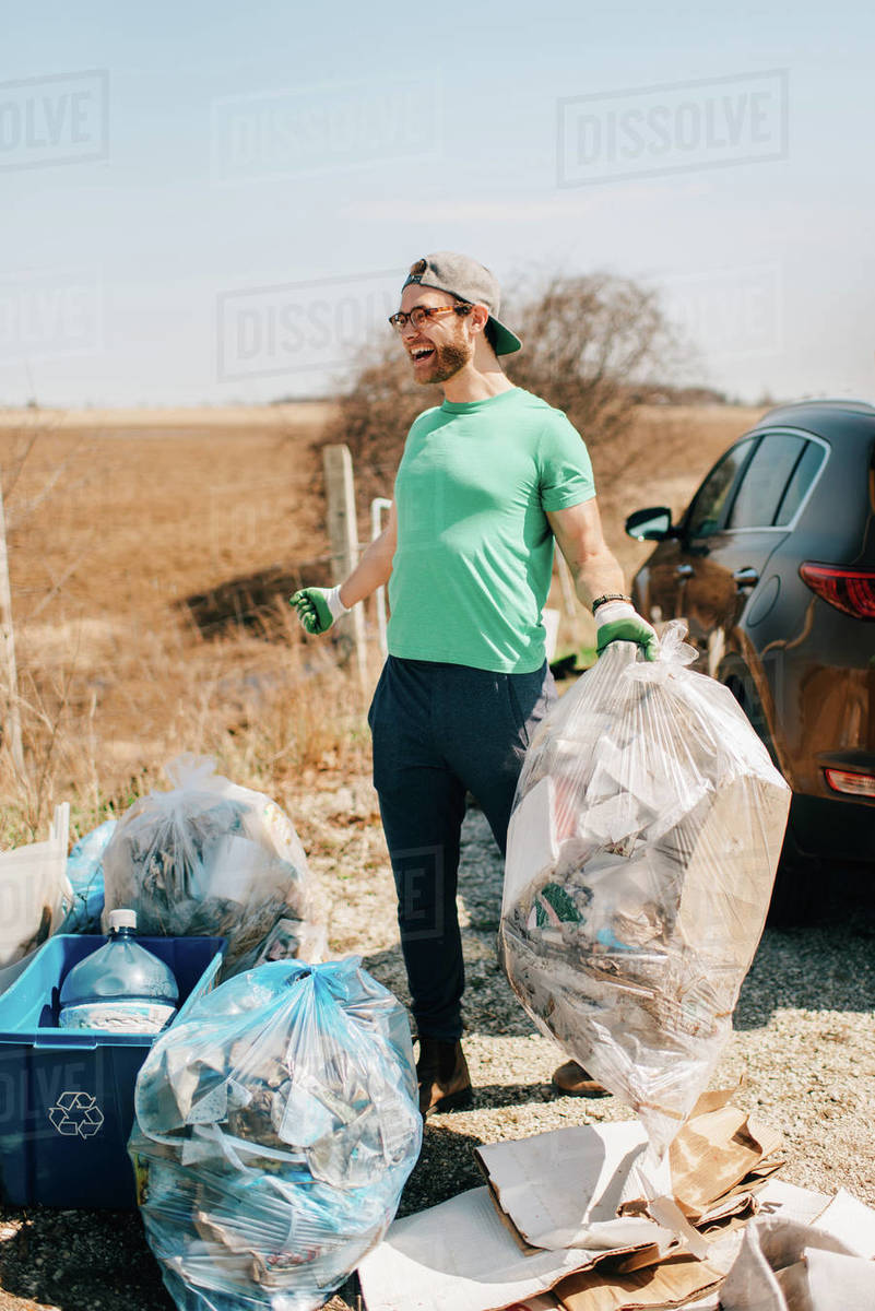 Man picking up rubbish by field, Georgetown, Canada - Stock Photo ...