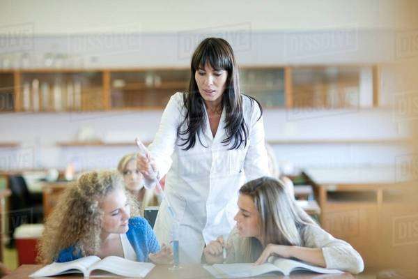 Science teacher in class - Royalty-free Stock Photo | Dissolve