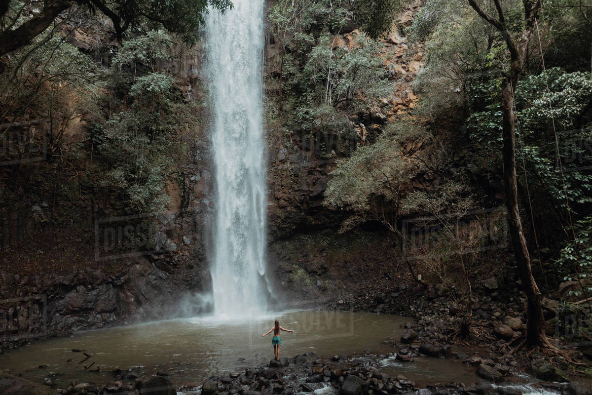 Woman enjoying waterfall, Princeville, Hawaii, US - Royalty-free Stock ...