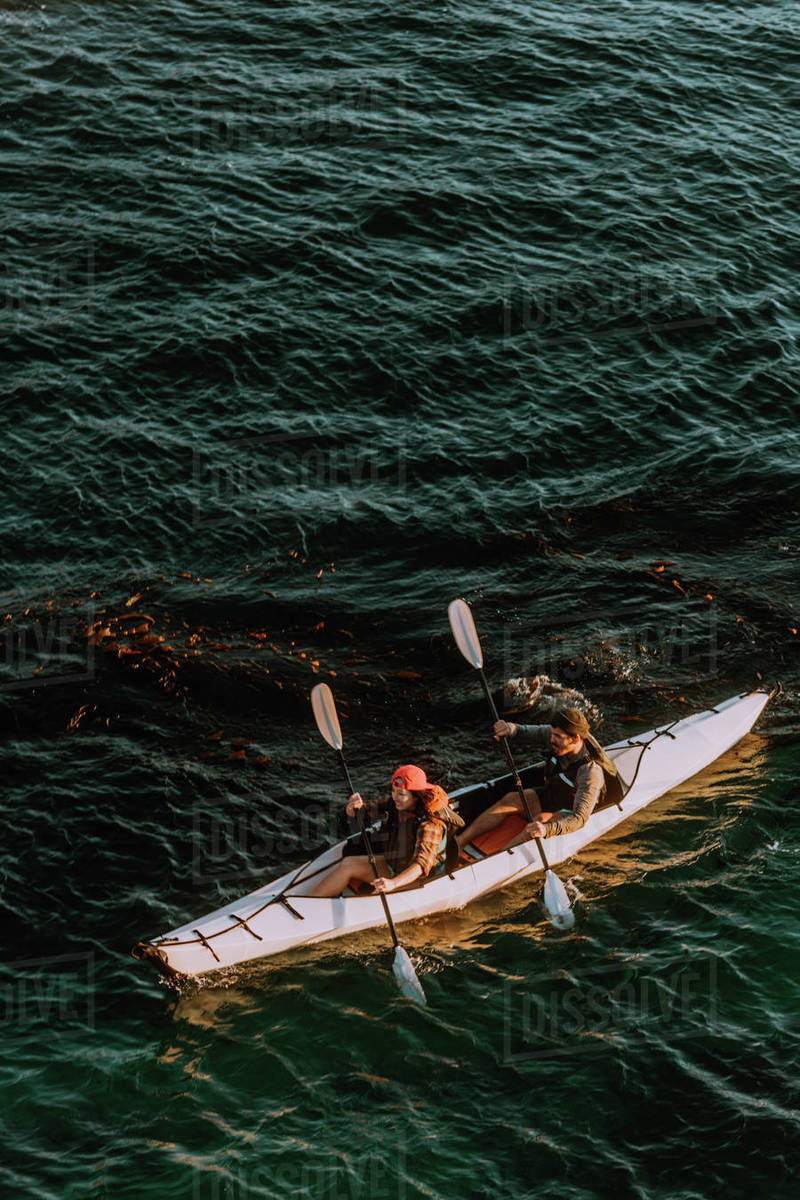 Friends kayaking in sea - Royalty-free Stock Photo | Dissolve