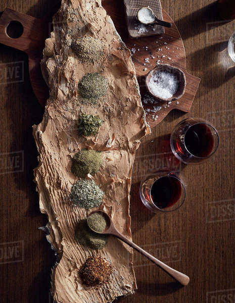 Variety of bush spices on log platter, a bush tucker dish using ...