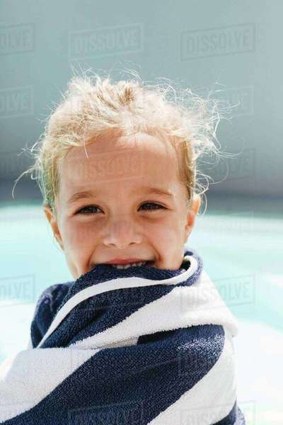 Happy little girl wrapped in towel by swimming pool - Royalty-free ...